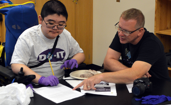 NNL leader Scott Bellman works with an NNL student on a brain ...